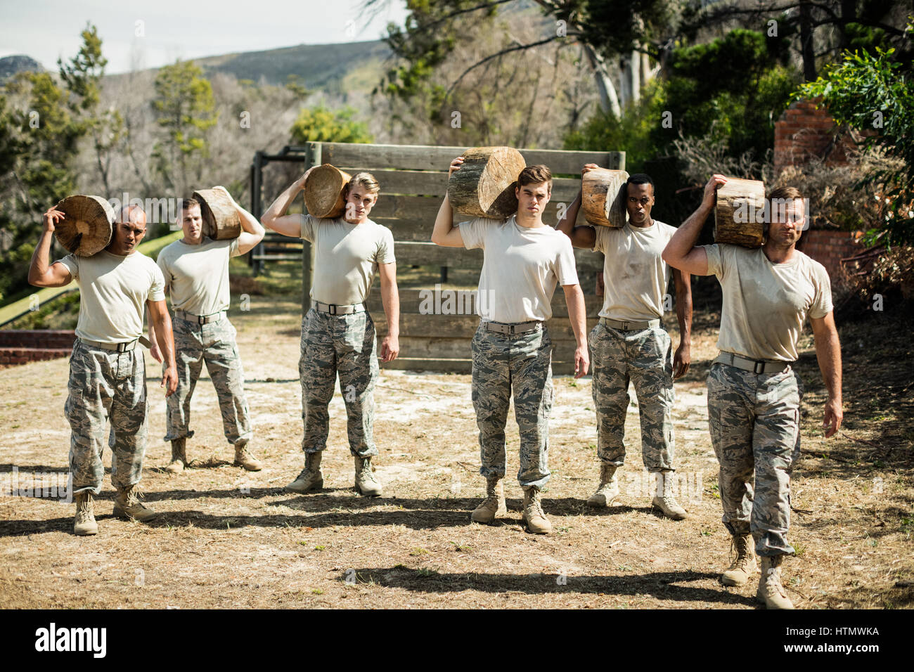 Soldiers carrying a tree log in boot camp Stock Photo - Alamy