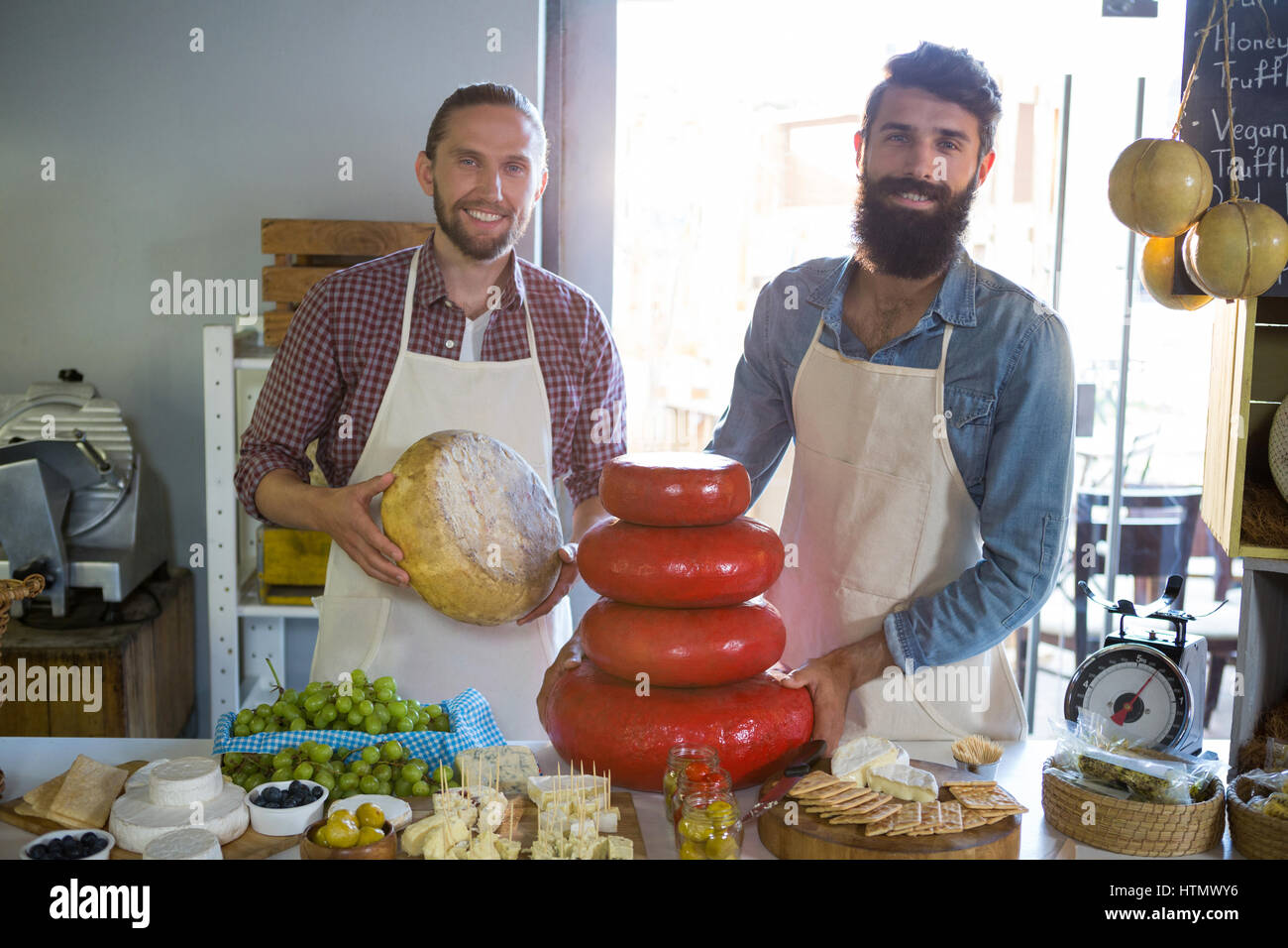 Portrait of smiling staff working at counter in market Stock Photo - Alamy