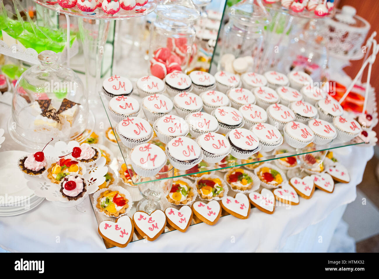 Different sweets and cupcakes at catering wedding reception table Stock ...