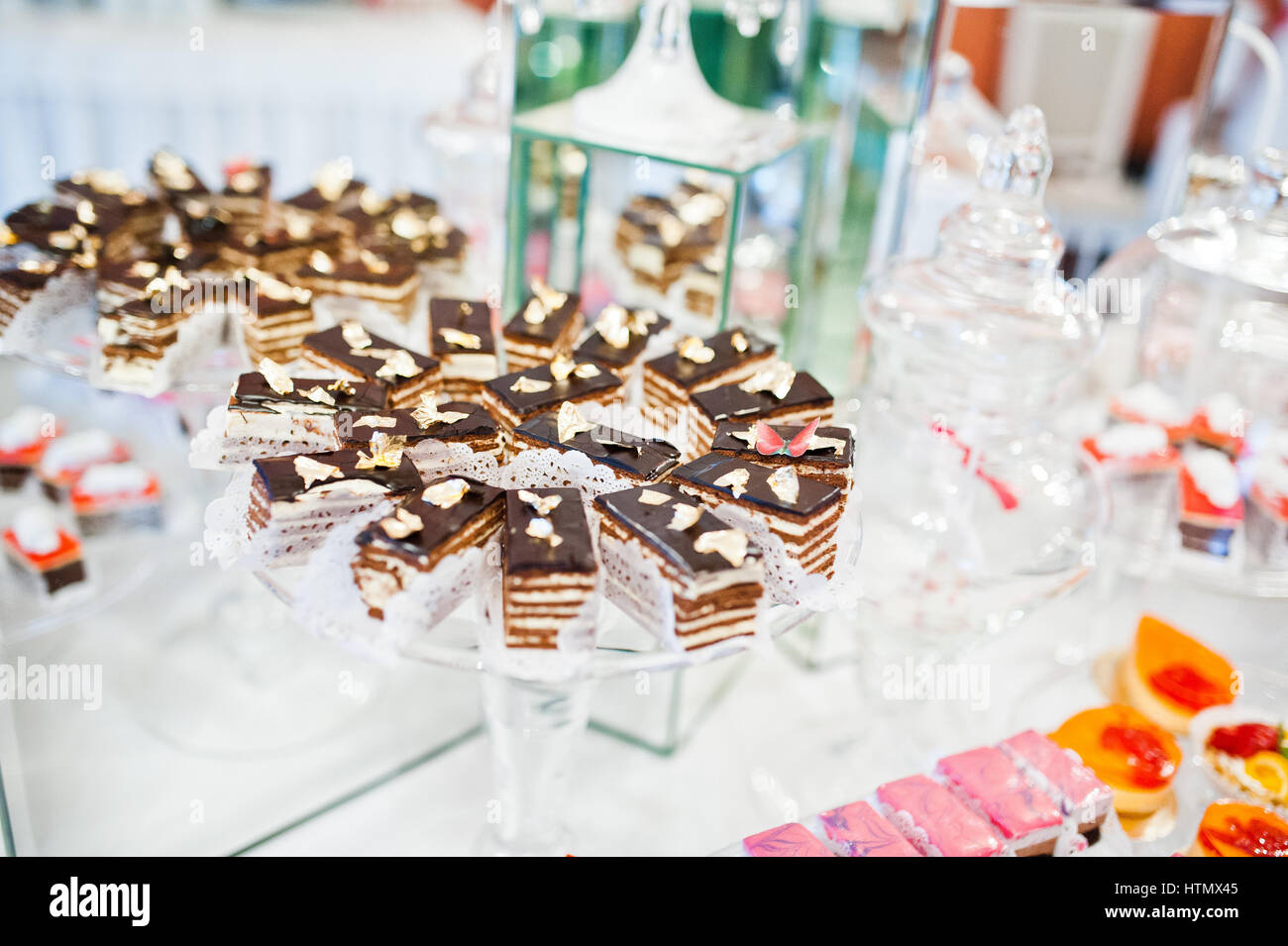 Different sweets and cupcakes at catering wedding reception table Stock ...