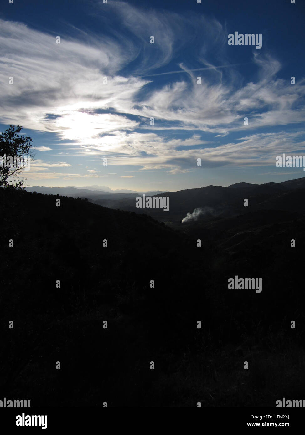 Frailes. Distant bonfire smoke. Clouds and panoramic view with mountain ...