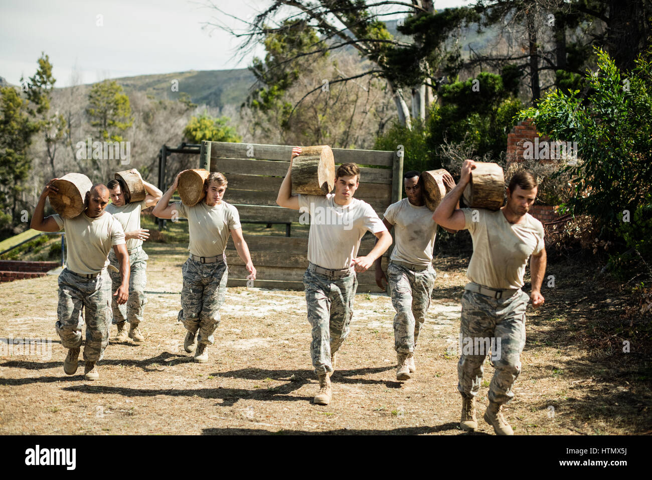 Soldiers carrying a tree log in boot camp Stock Photo - Alamy