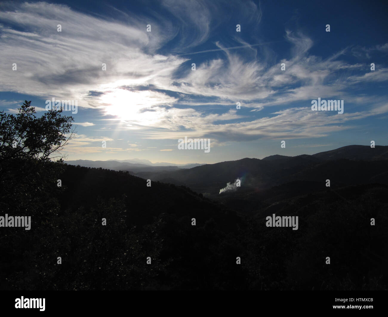 Frailes.Sky at evening time. Distant bonfire smoke. Clouds and ...