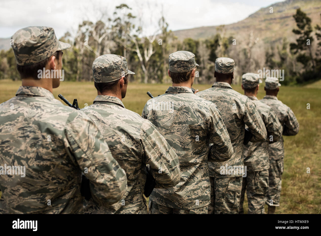 Group of military soldiers standing with rifles at boot camp Stock ...