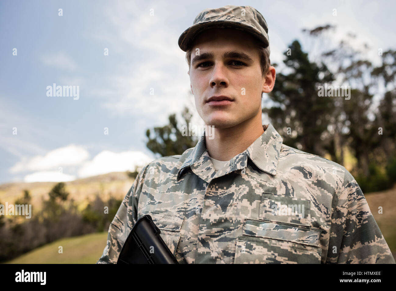 Portrait of military soldier guarding with a rifle in boot camp Stock ...