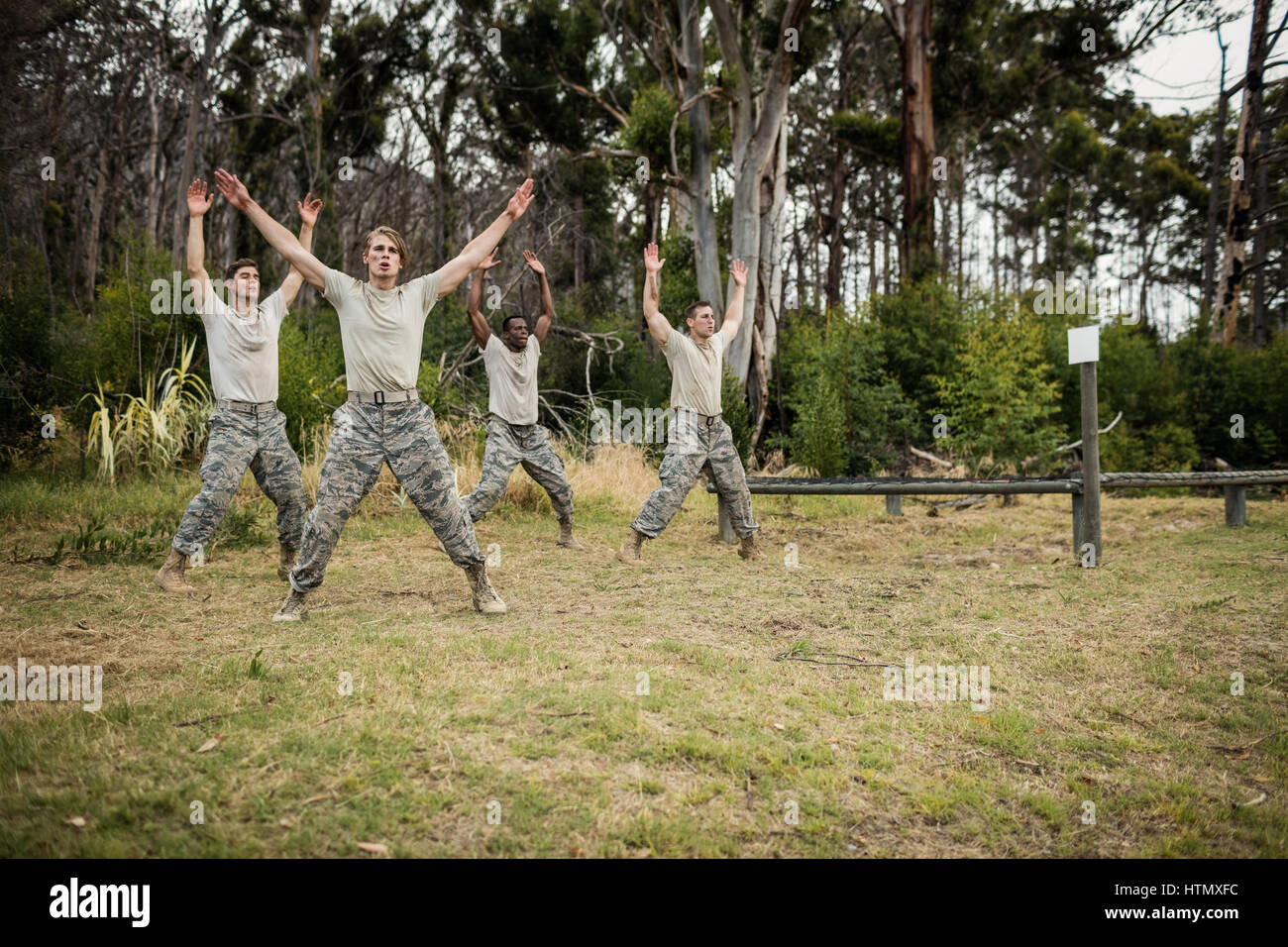 Soldiers performing stretching exercise in boot camp Stock Photo - Alamy