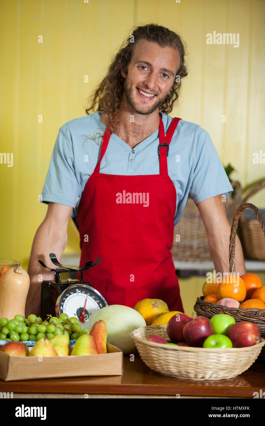 Portrait of smiling staff standing at counter in market Stock Photo - Alamy