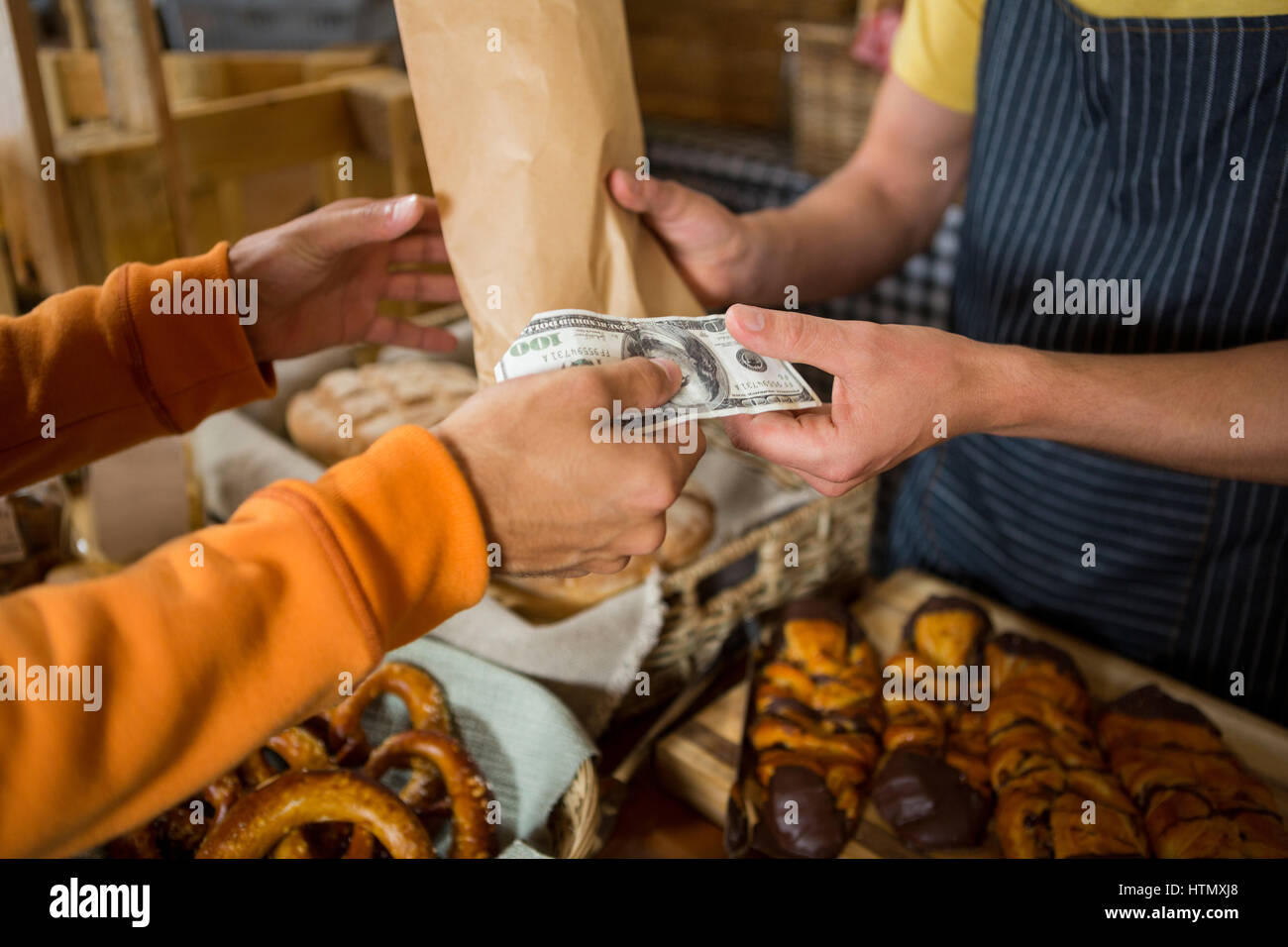 Customer paying bill by cash at bread counter in bakery shop Stock ...