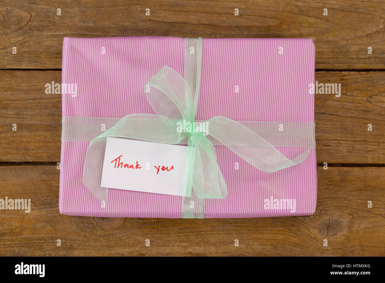 Thank you card with gift box on wooden table Stock Photo - Alamy