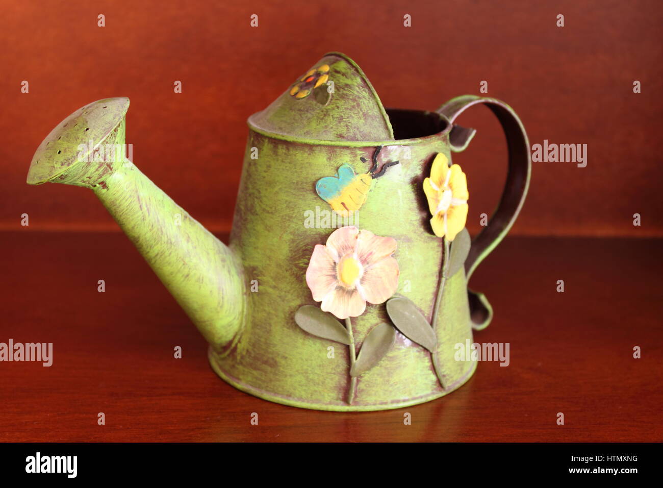 A decorated metal watering can Stock Photo - Alamy
