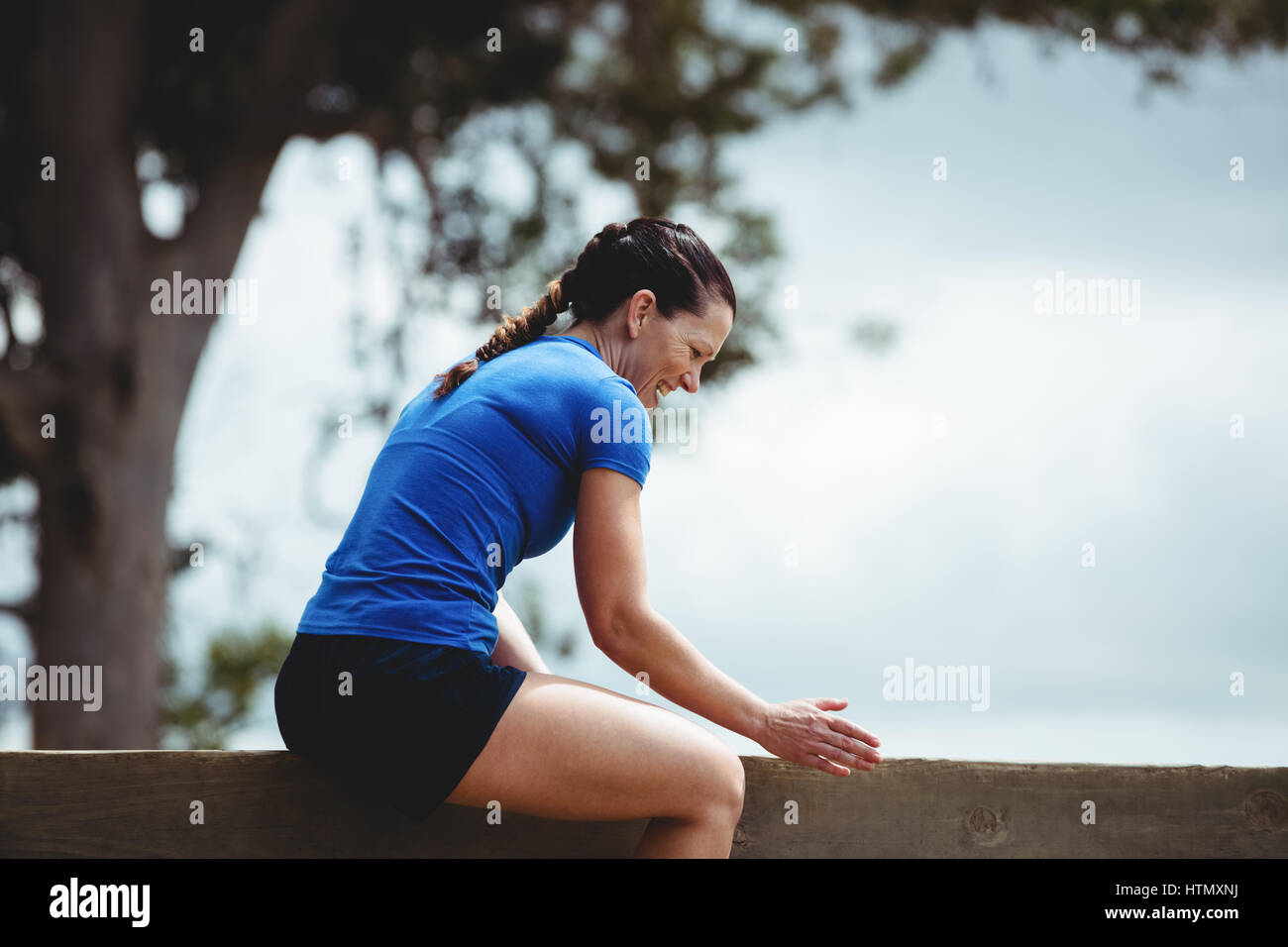 Woman climbing over wall hi-res stock photography and images - Alamy