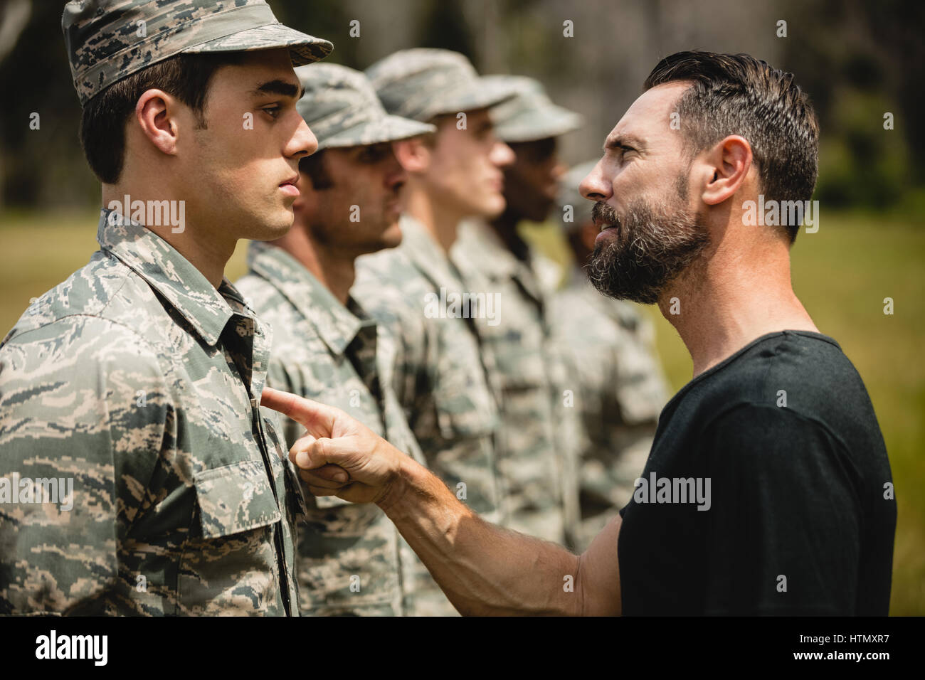 Trainer giving training to military soldier at boot camp Stock Photo ...