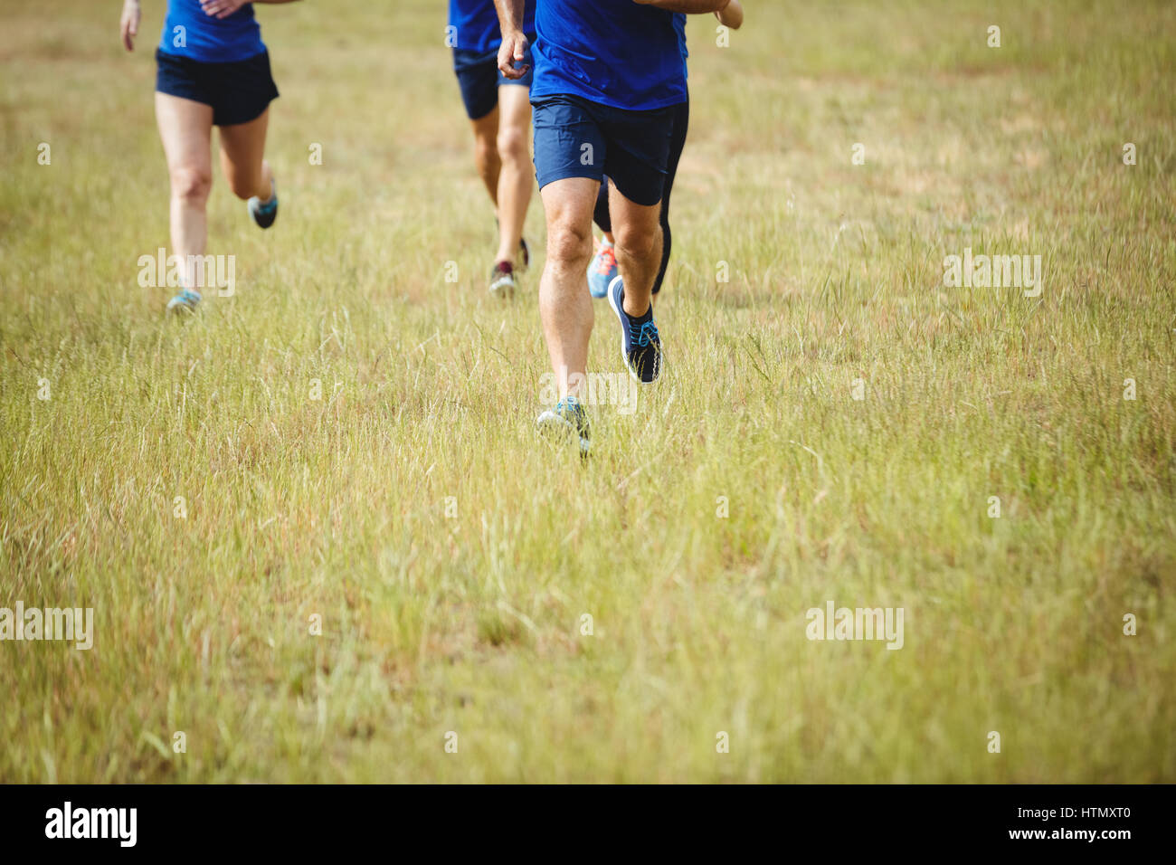 Low section of fit people running in boot camp Stock Photo - Alamy