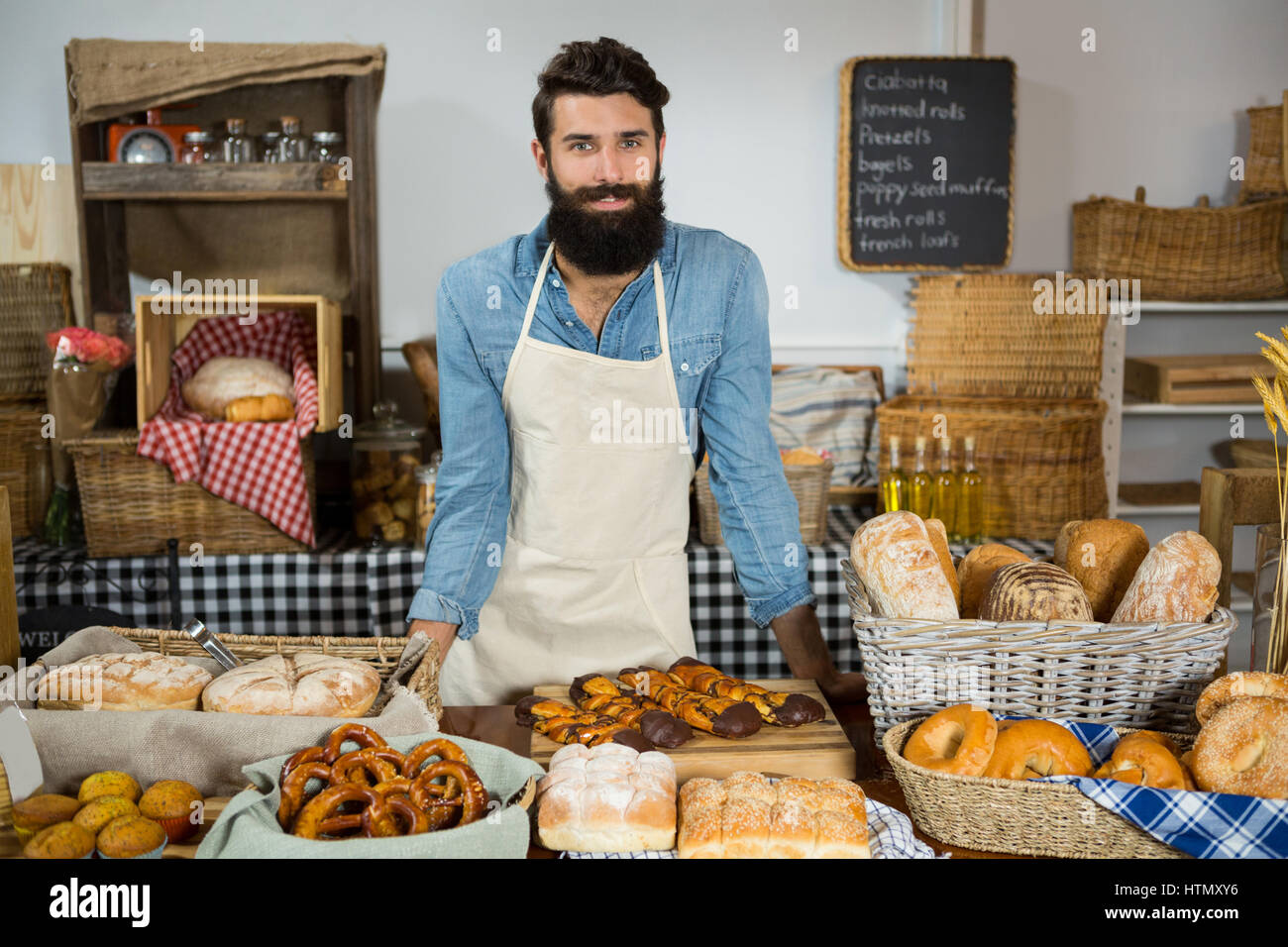 Portrait of male staff standing at bakery counter in market Stock Photo ...