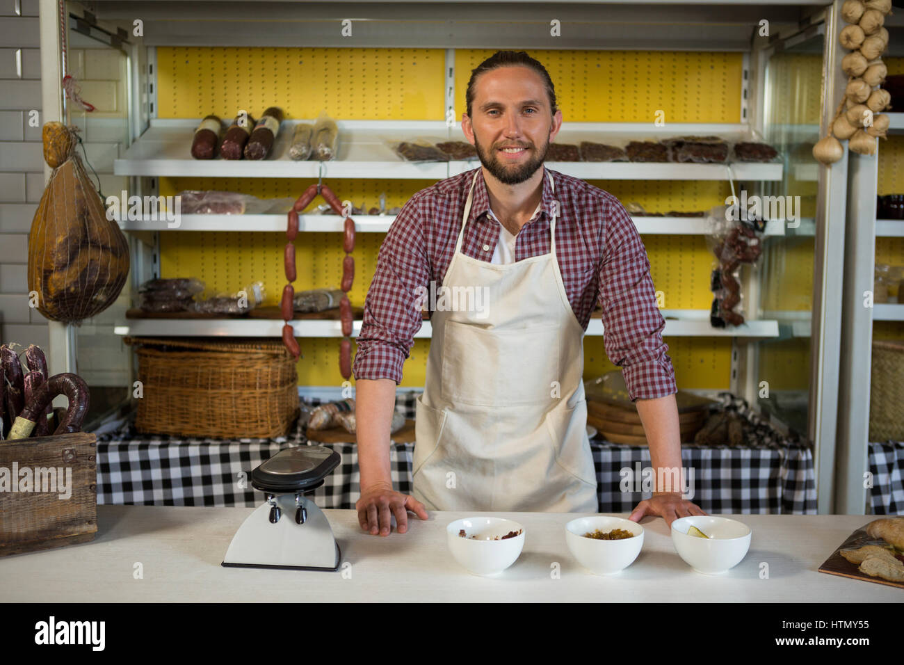 Portrait of smiling male staff standing at meat counter in market Stock ...