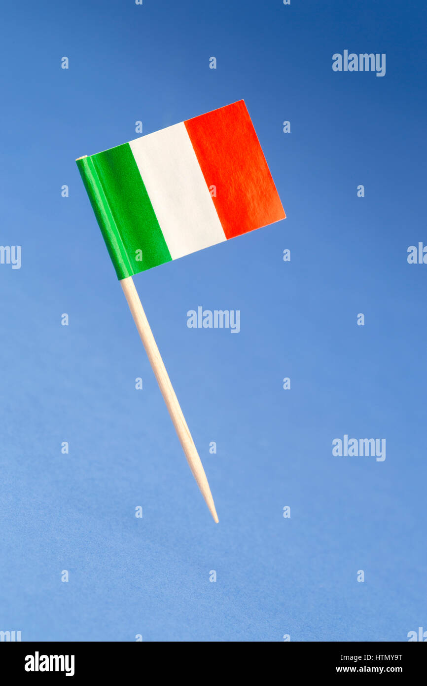 Paper flag of Italy on blue background Stock Photo - Alamy