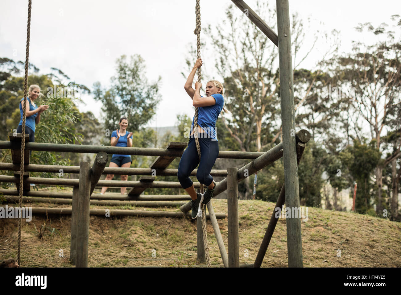 Fit woman climbing down rope hi-res stock photography and images - Alamy