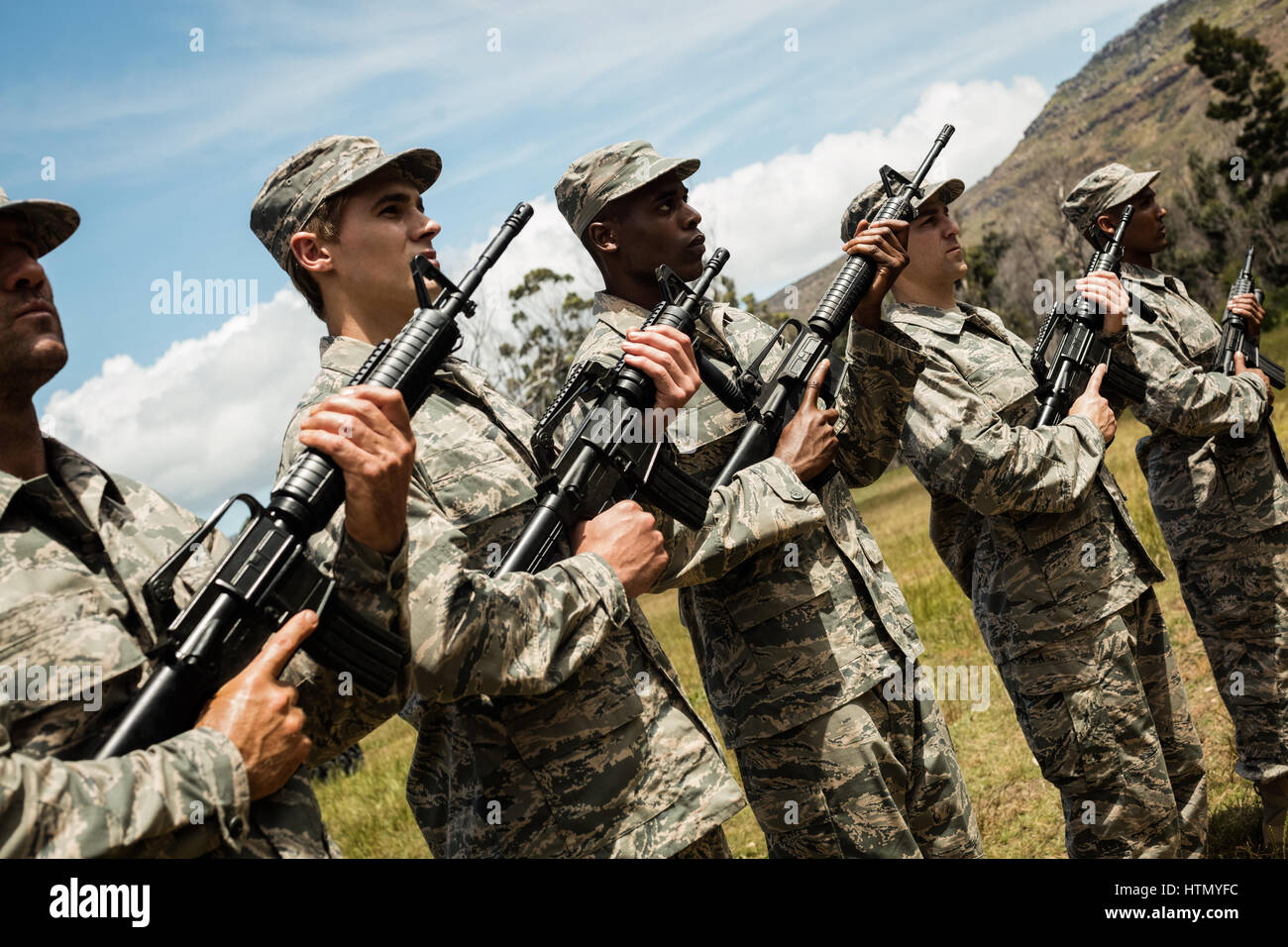Group of military soldiers standing with rifles at boot camp Stock ...