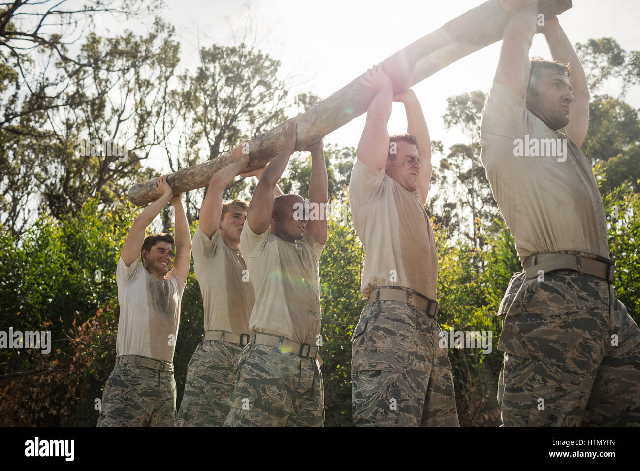 Soldiers carrying a tree log in boot camp Stock Photo - Alamy