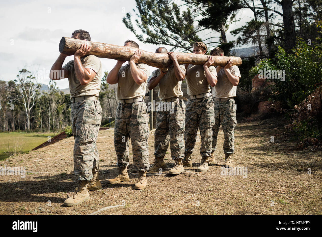 Soldiers carrying a tree log in boot camp Stock Photo - Alamy