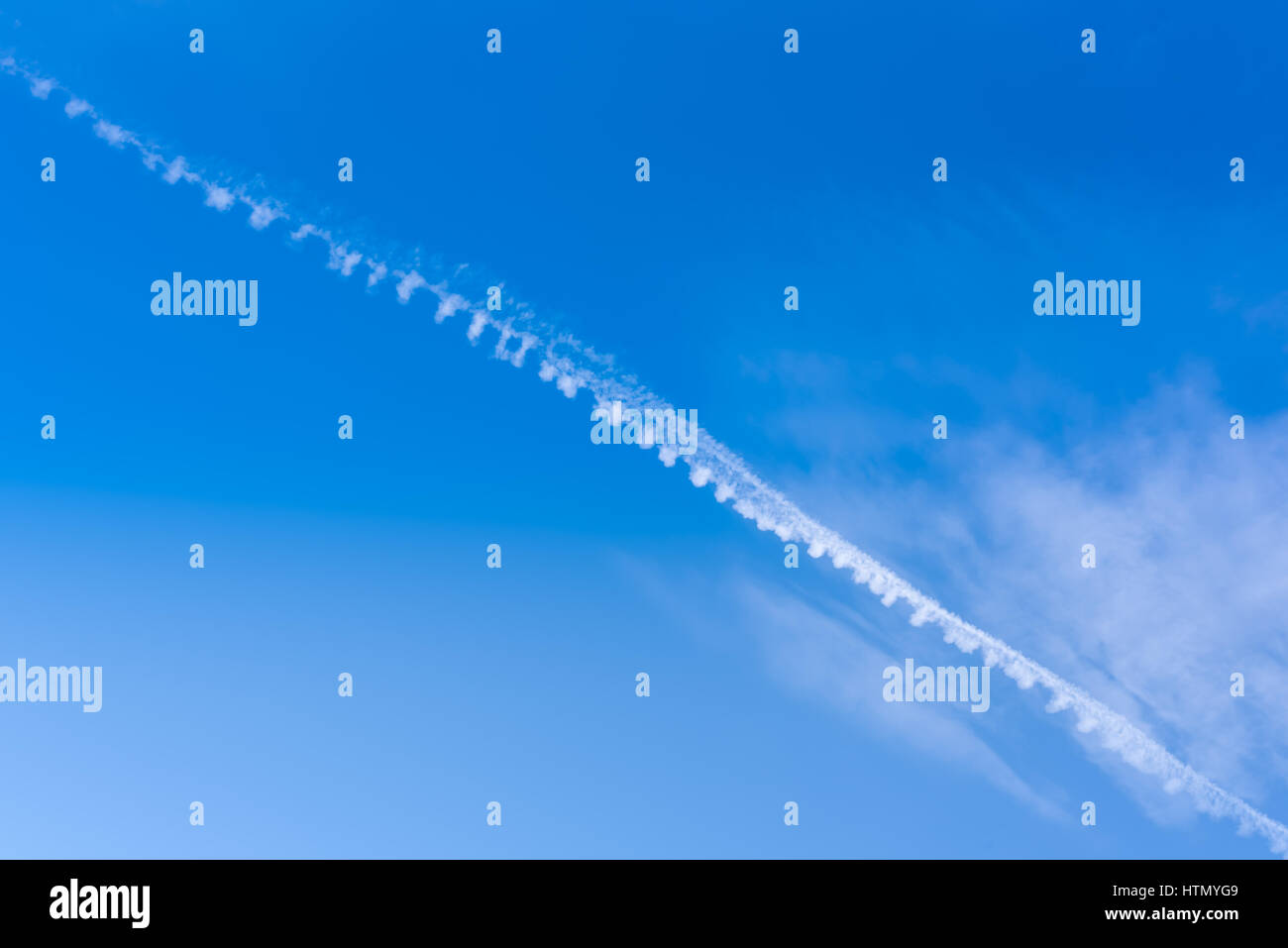 Bright blue sky background with a diagonal jet plane trace, track Stock ...