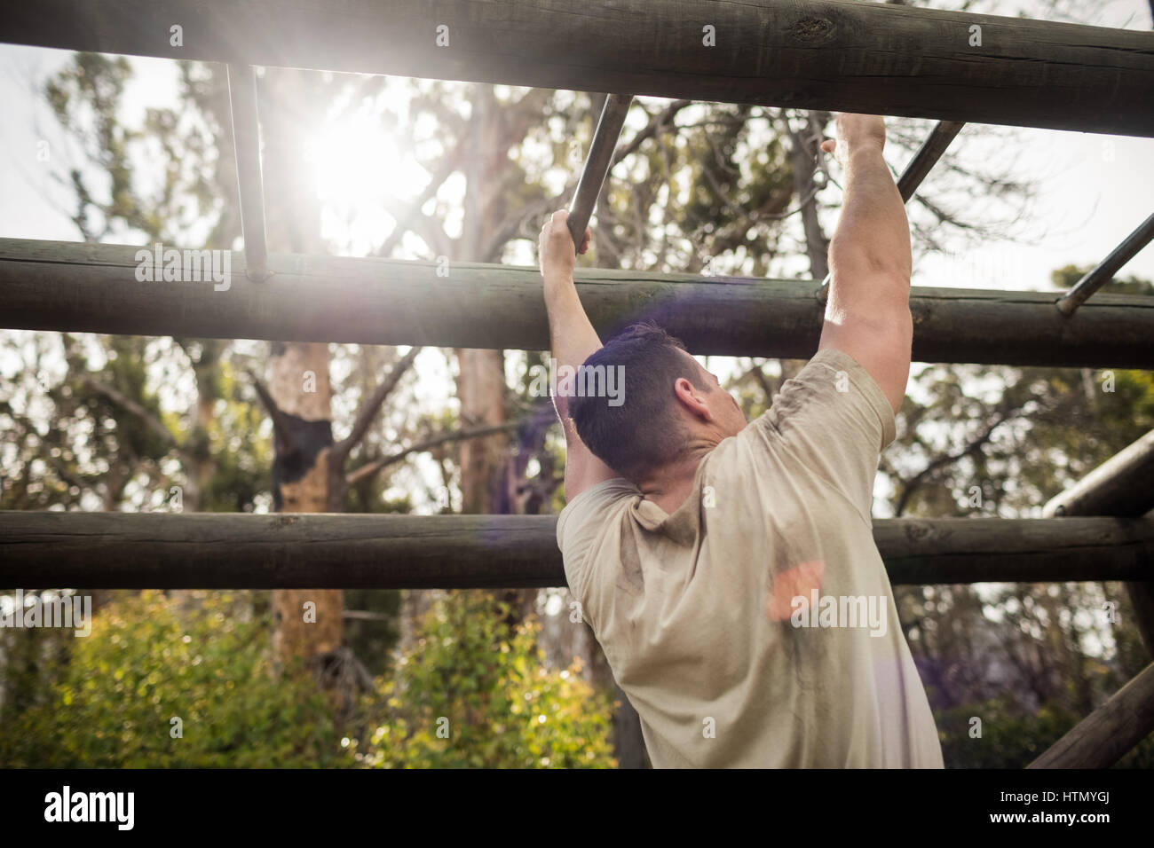 Soldier climbing monkey bars in boot camp Stock Photo - Alamy