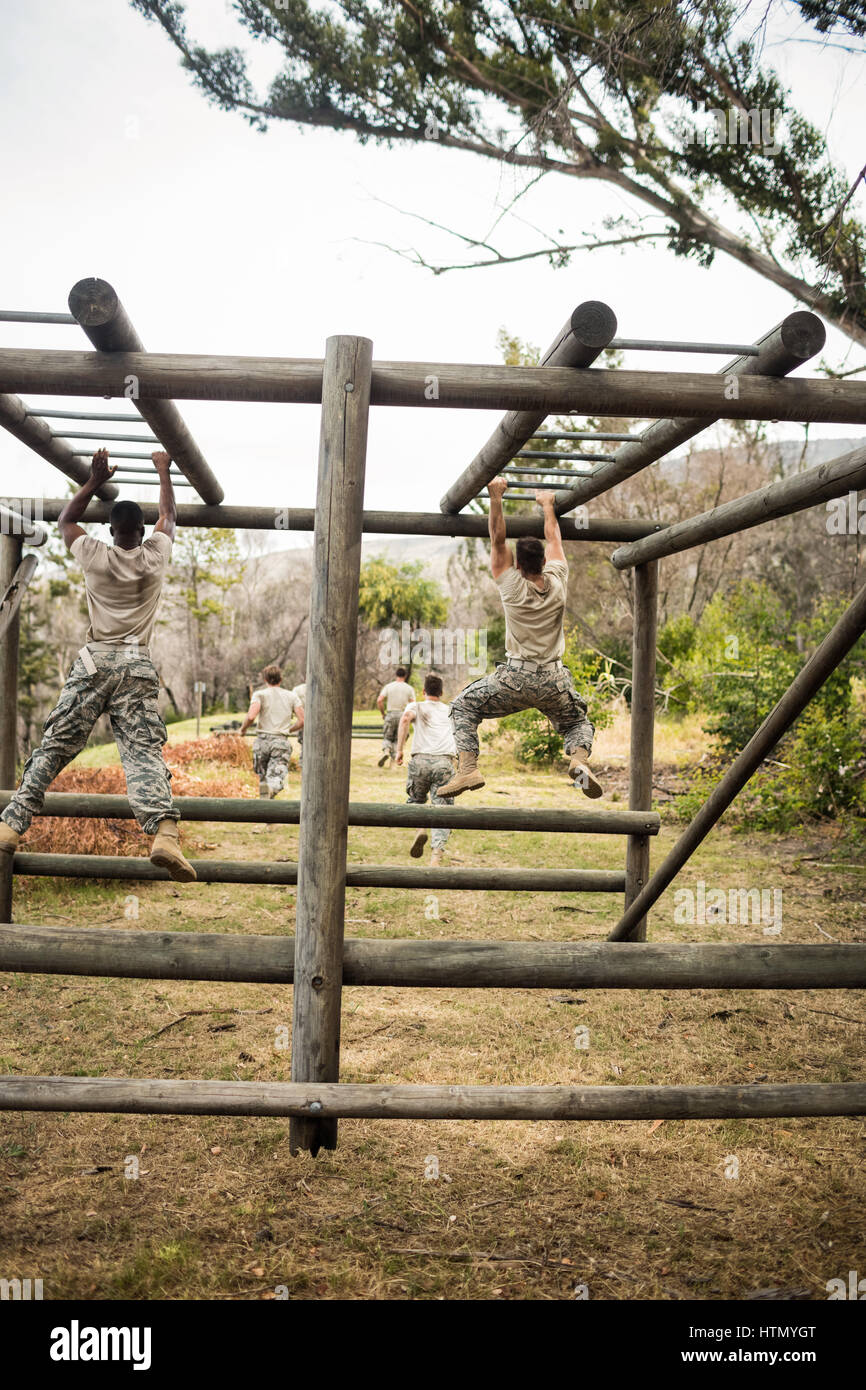 Rear view of Soldiers climbing monkey bars Stock Photo - Alamy