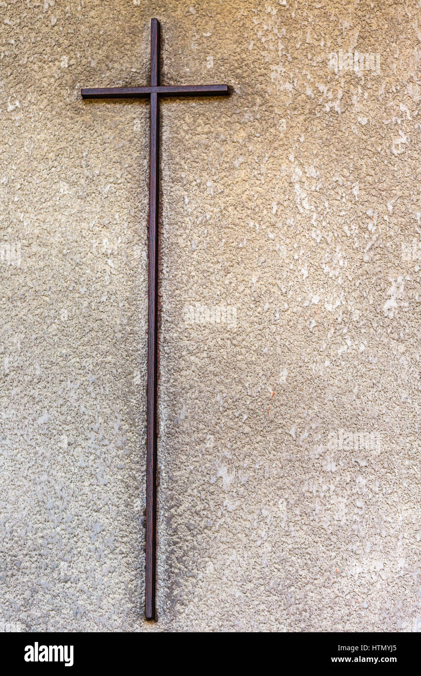 Long iron Catholic Cross on wall Stock Photo - Alamy