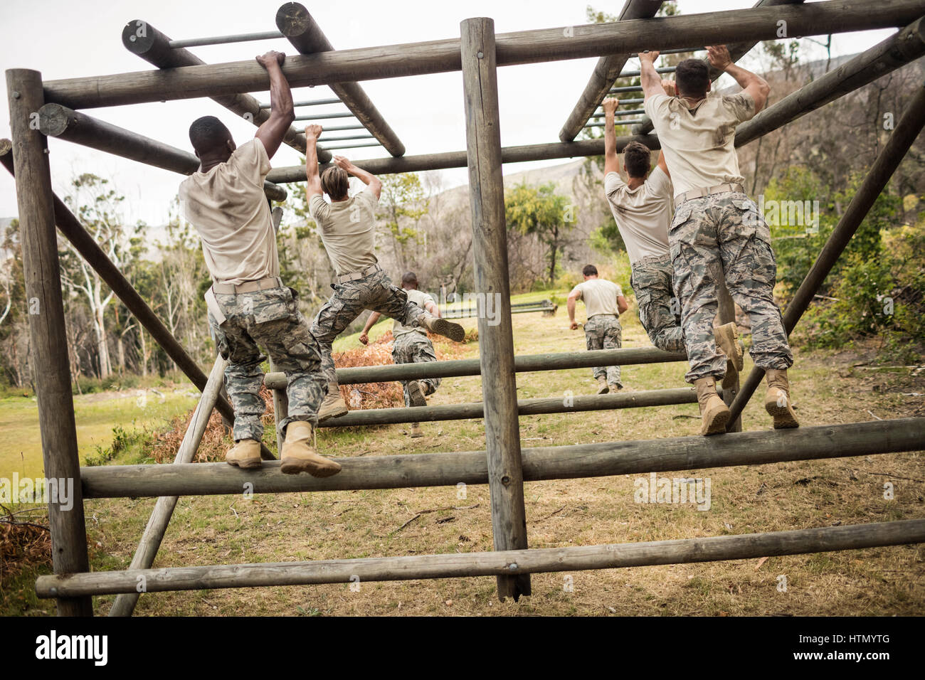 Rear view of soldiers climbing monkey bars Stock Photo - Alamy