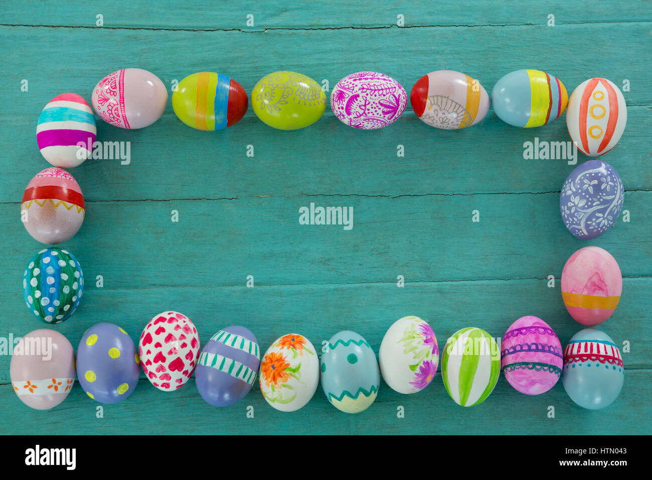 Close-up of painted Easter eggs arranged in rectangle shape on wooden ...