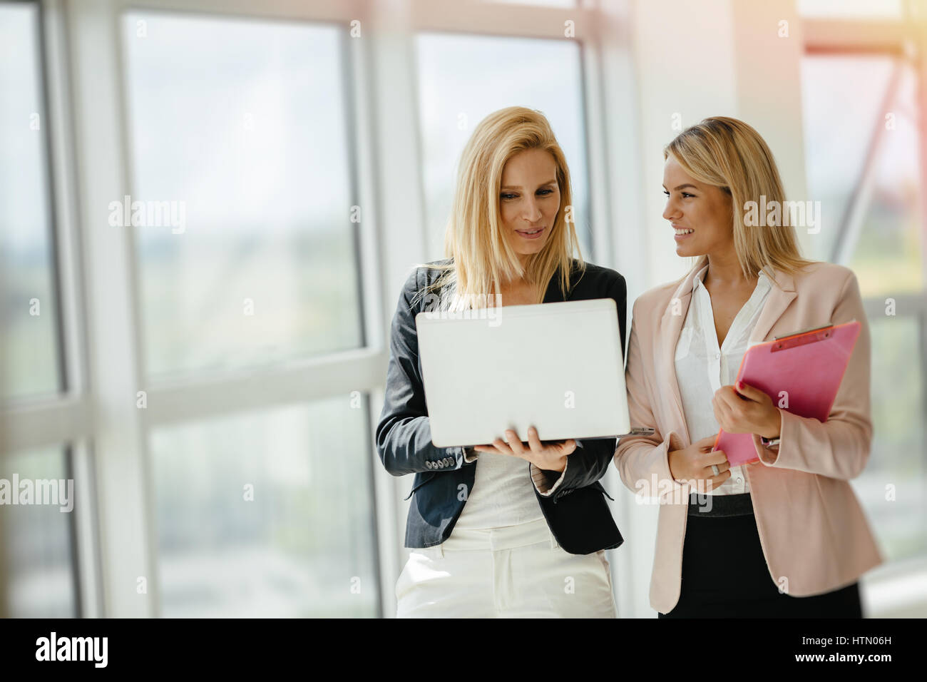 Business women colleagues at work talking Stock Photo - Alamy