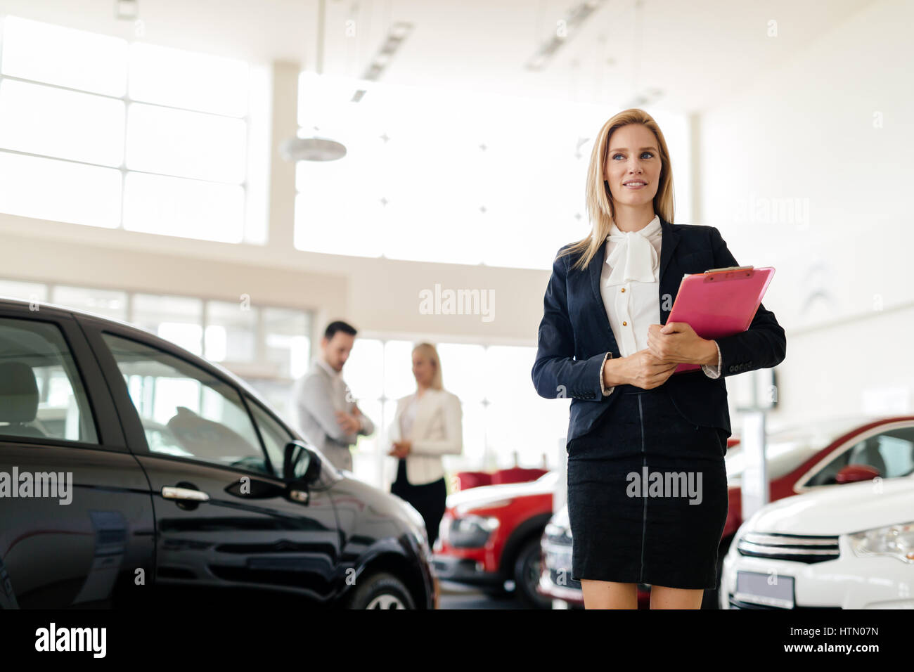 Salesperson selling cars at car dealership Stock Photo - Alamy