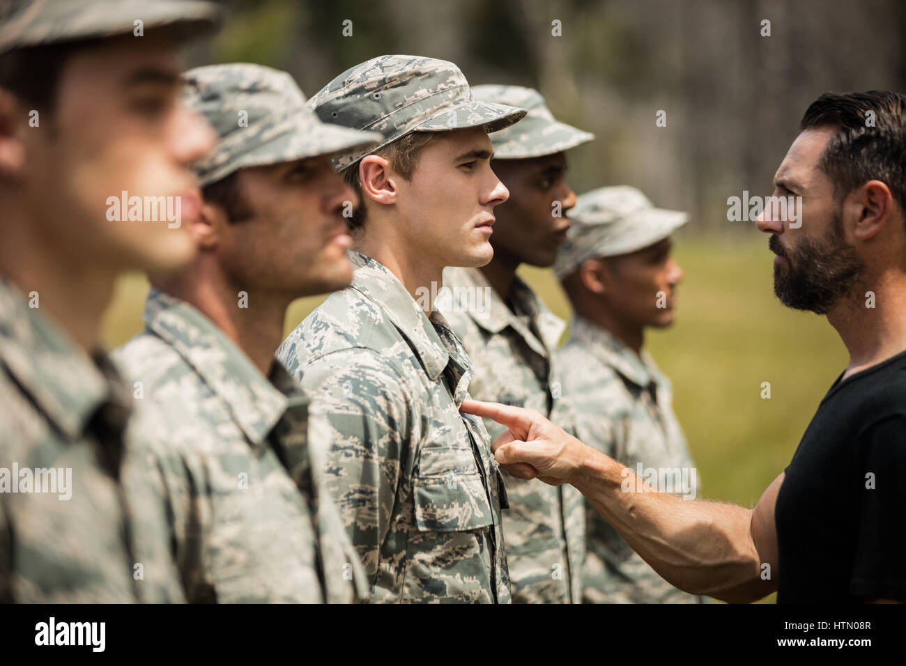 Trainer giving training to military soldier at boot camp Stock Photo ...
