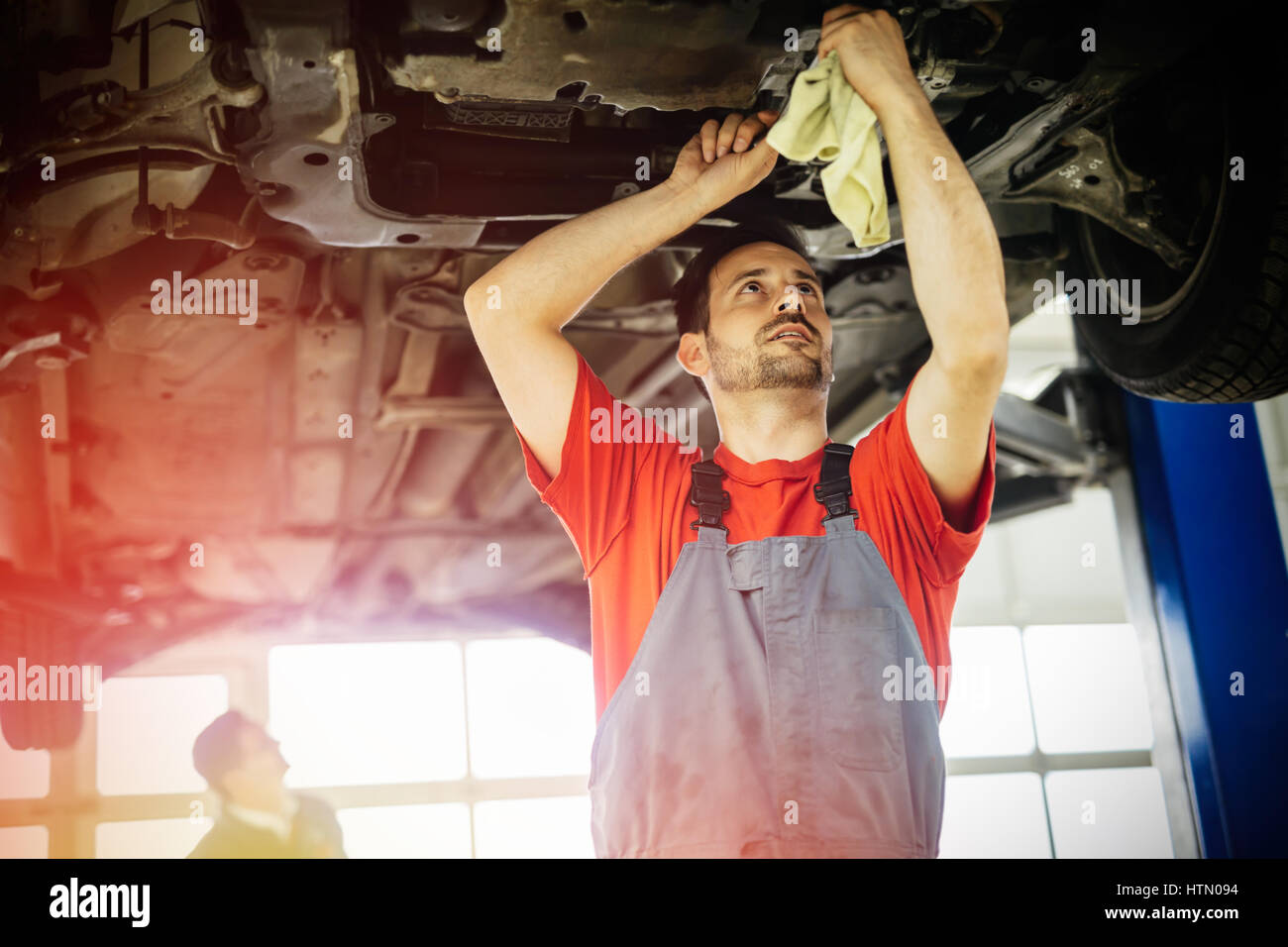 Car mechanics working on car maintenance Stock Photo - Alamy