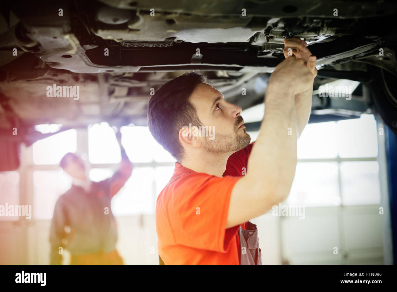 Car mechanics working on car maintenance Stock Photo - Alamy