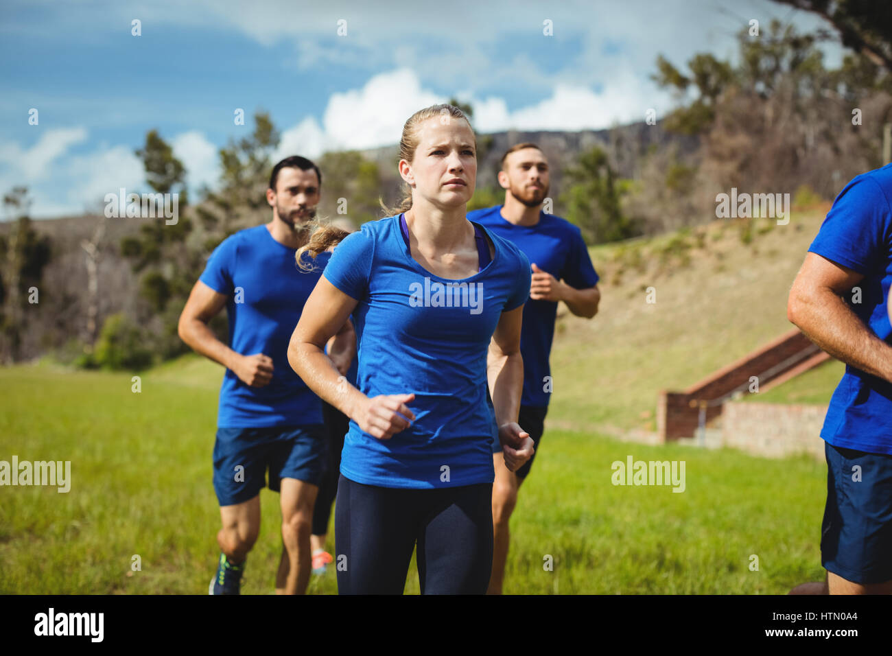 Fit people running in boot camp Stock Photo - Alamy