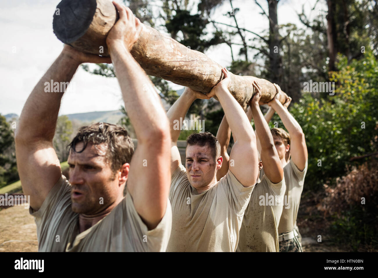 Soldiers carrying a tree log in boot camp Stock Photo - Alamy