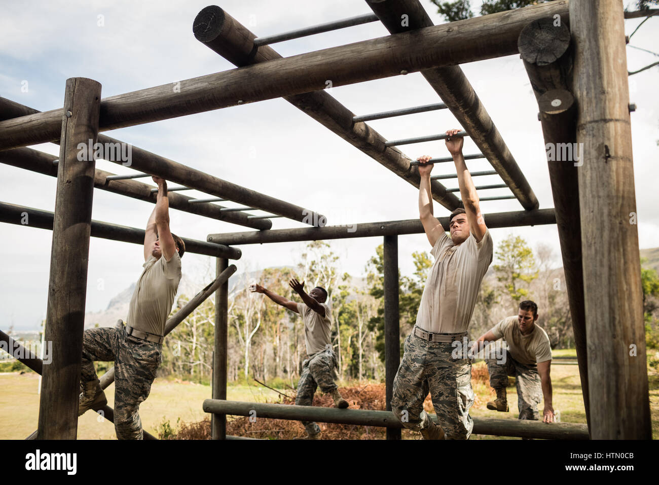 Soldiers climbing monkey bars in boot camp Stock Photo - Alamy