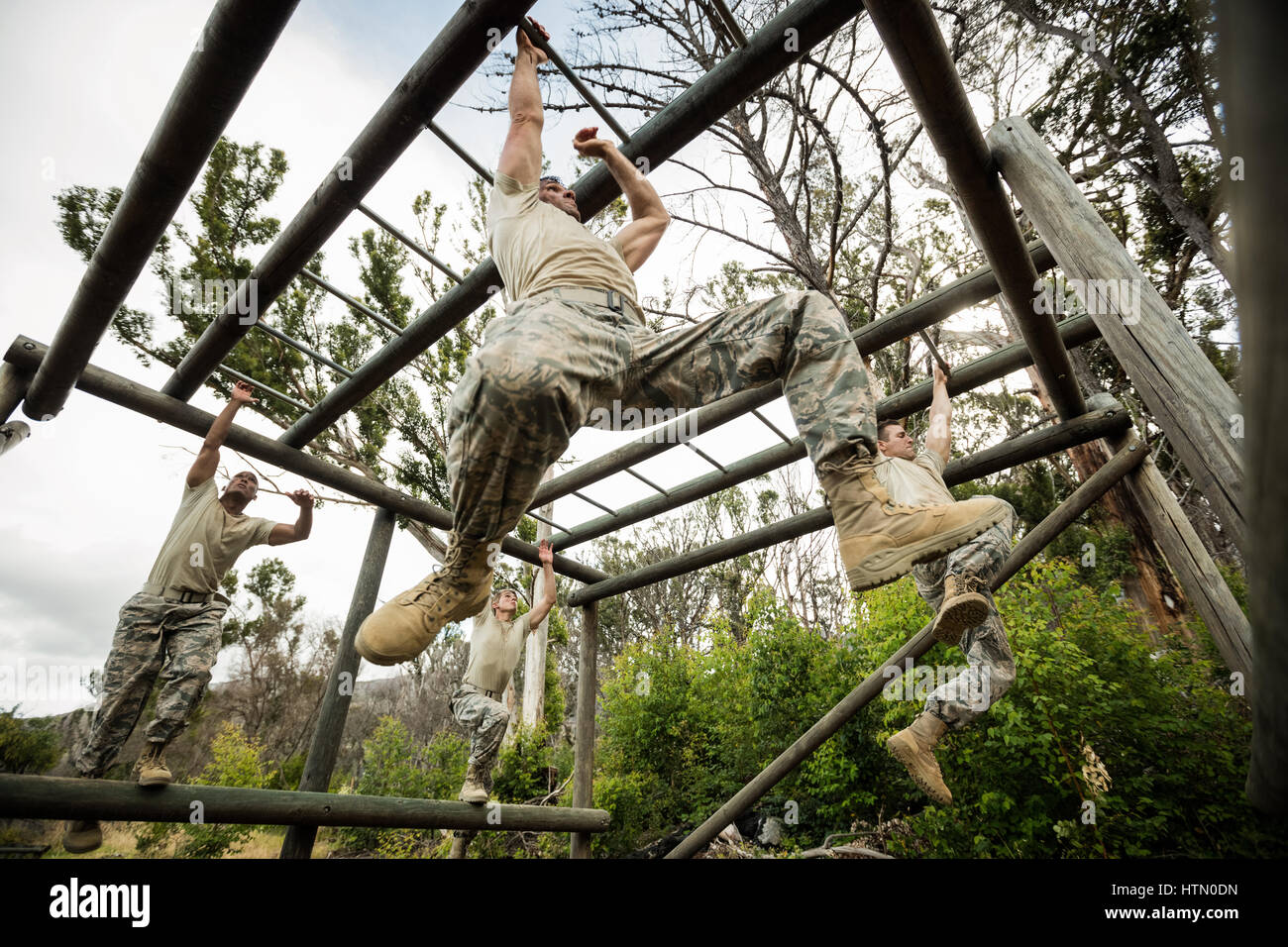 Soldiers climbing monkey bars in boot camp Stock Photo - Alamy