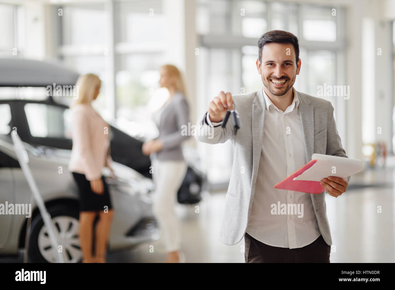 Salesperson selling cars at car dealership Stock Photo - Alamy