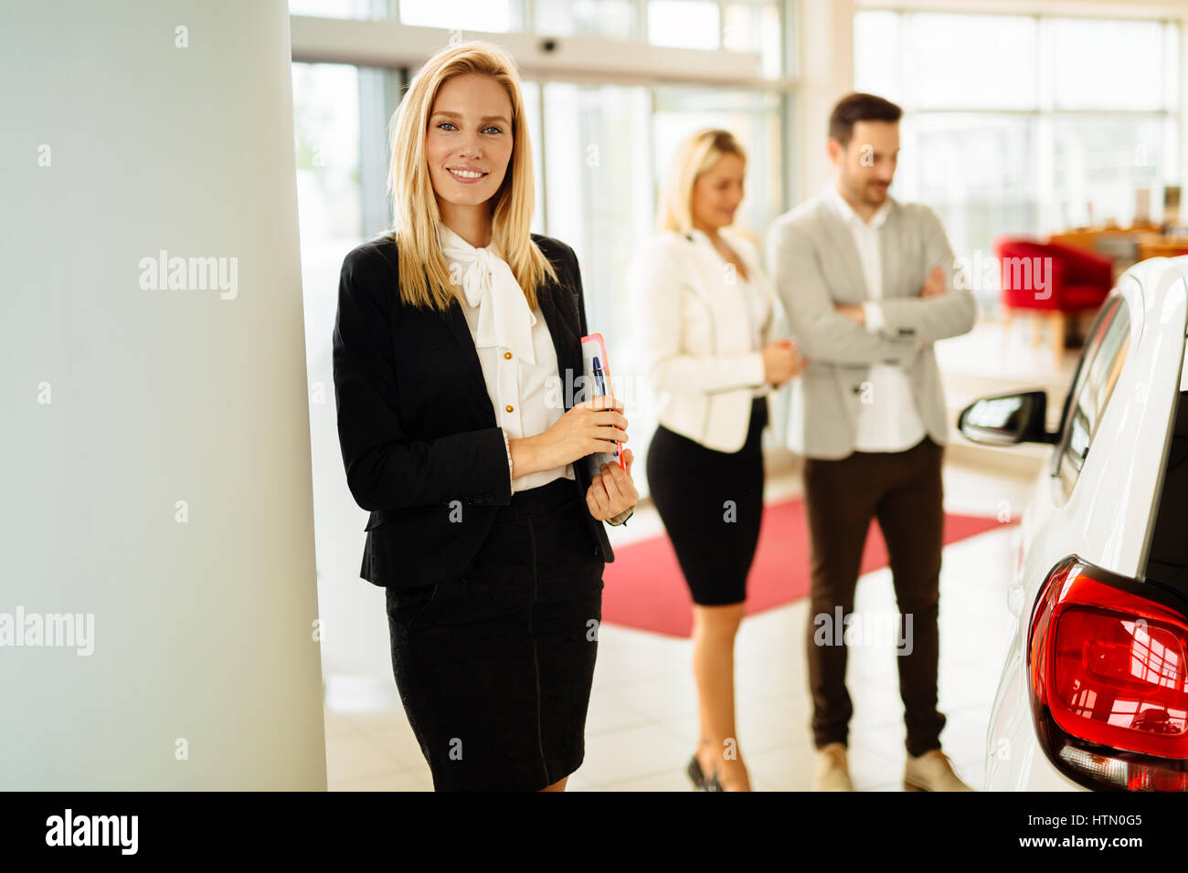 Salesperson selling cars at car dealership Stock Photo - Alamy