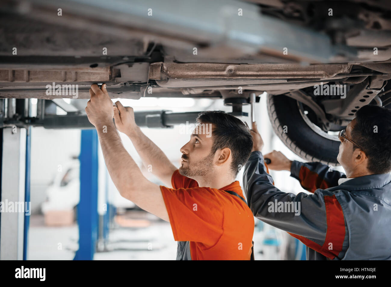 Car mechanics working on car maintenance Stock Photo - Alamy