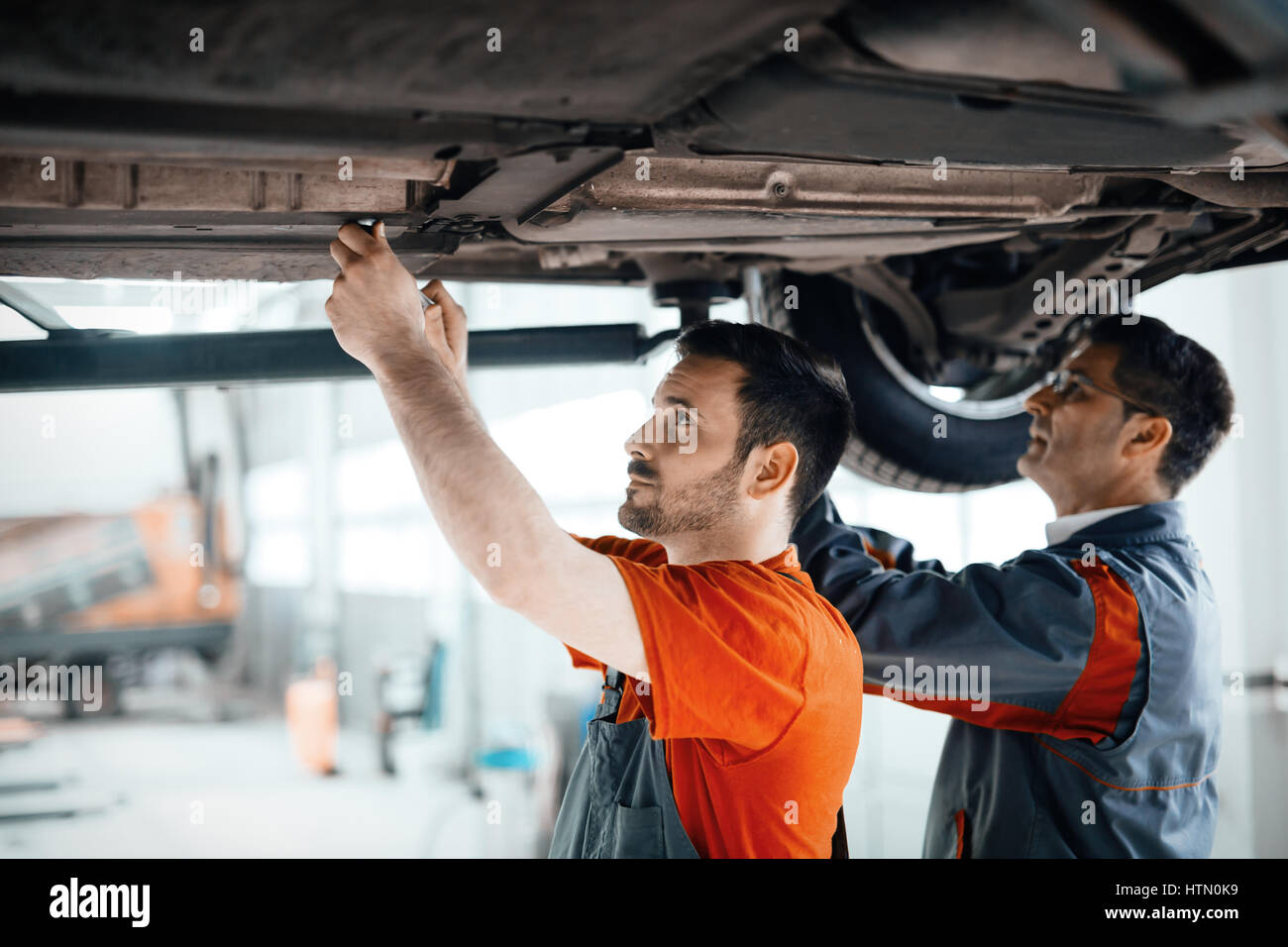 Car mechanic working at automotive service center Stock Photo - Alamy