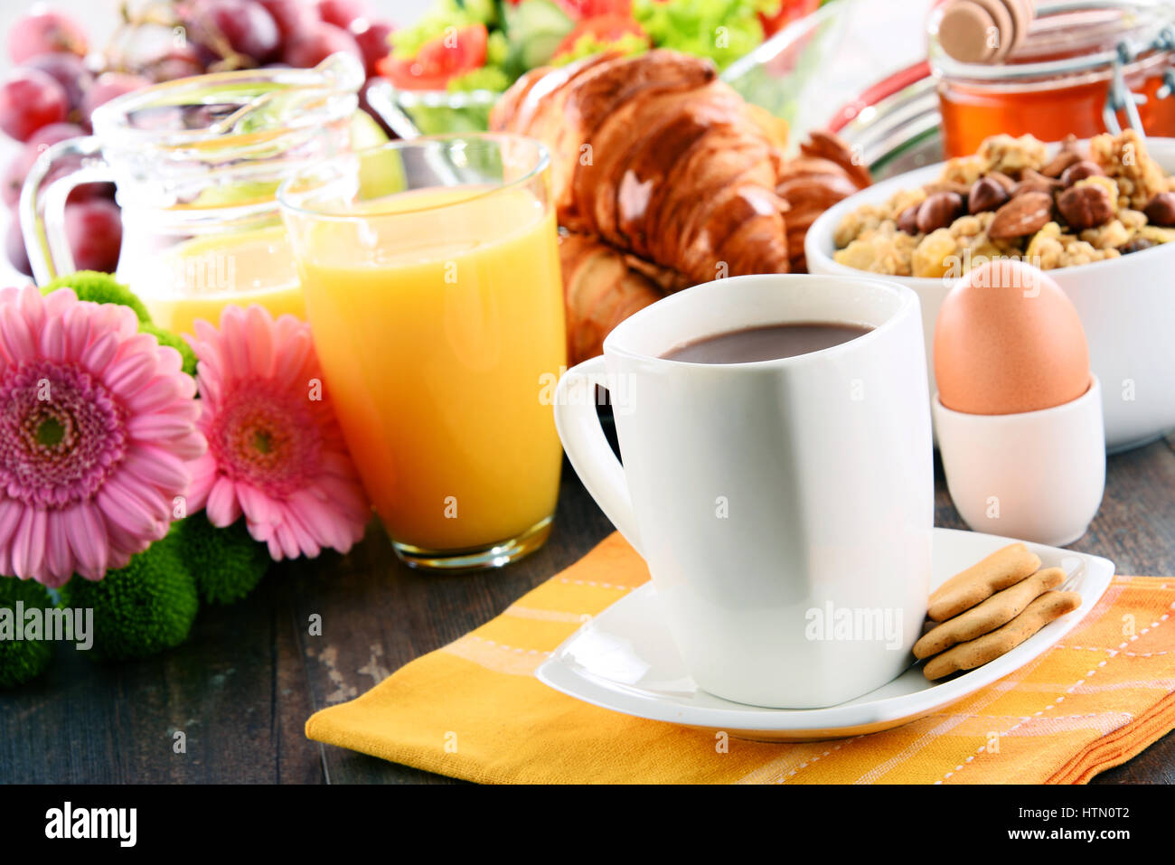 Breakfast consisting of fruits, orange juice, coffee, honey, bread and ...