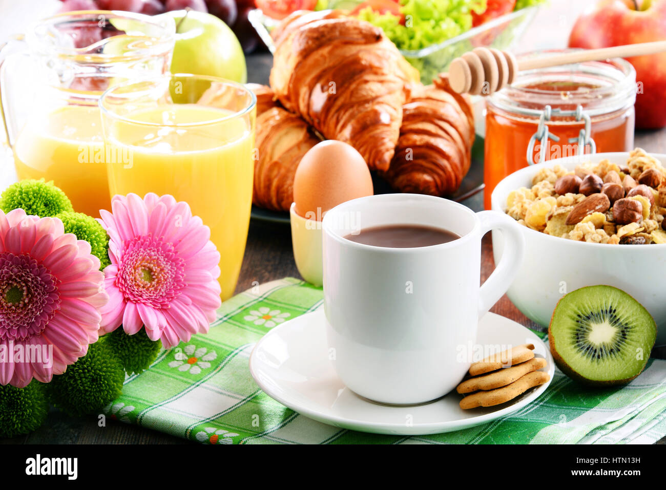 Breakfast consisting of fruits, orange juice, coffee, honey, bread and ...