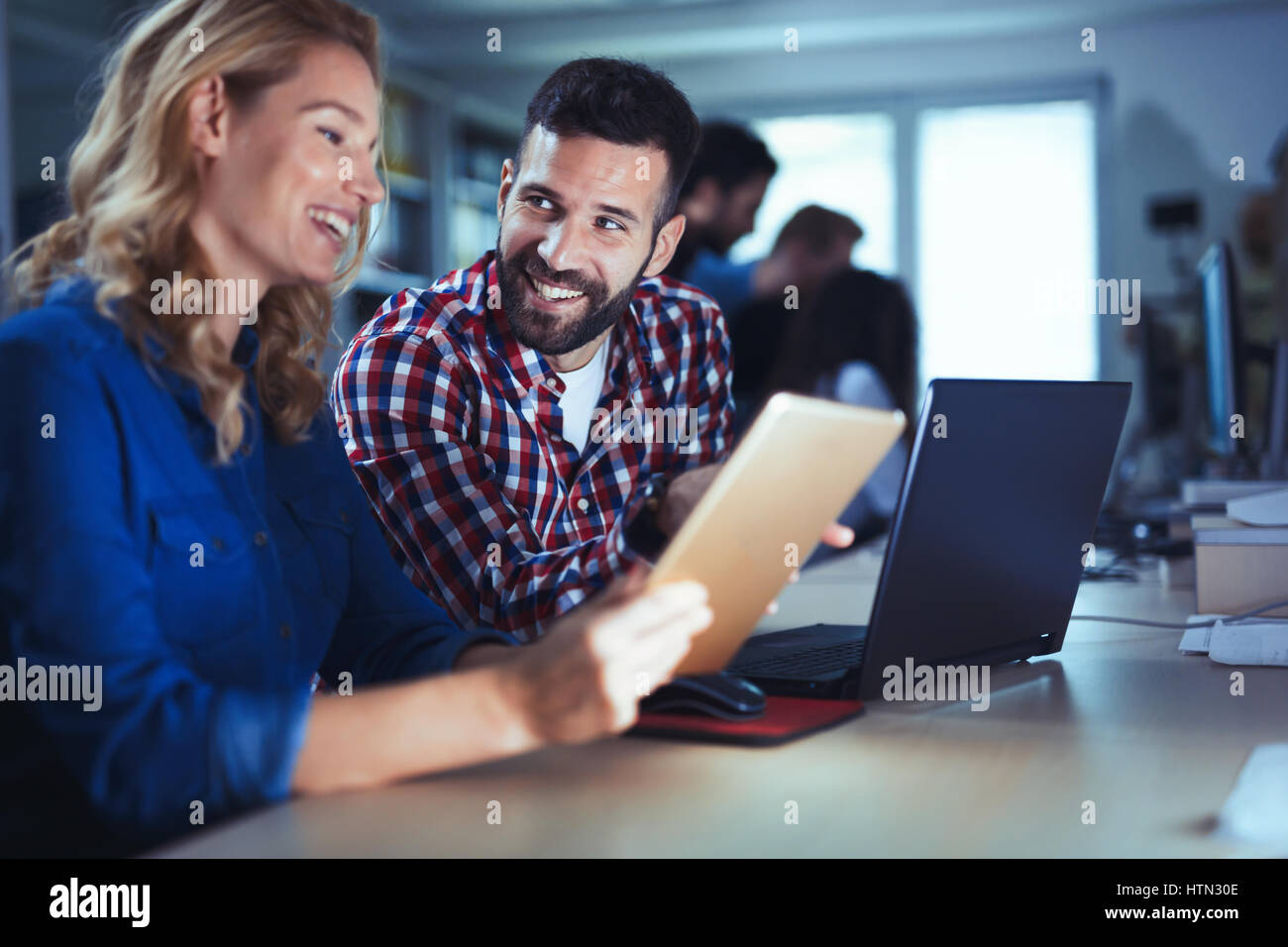 Programmers cooperating at IT company developing apps Stock Photo - Alamy