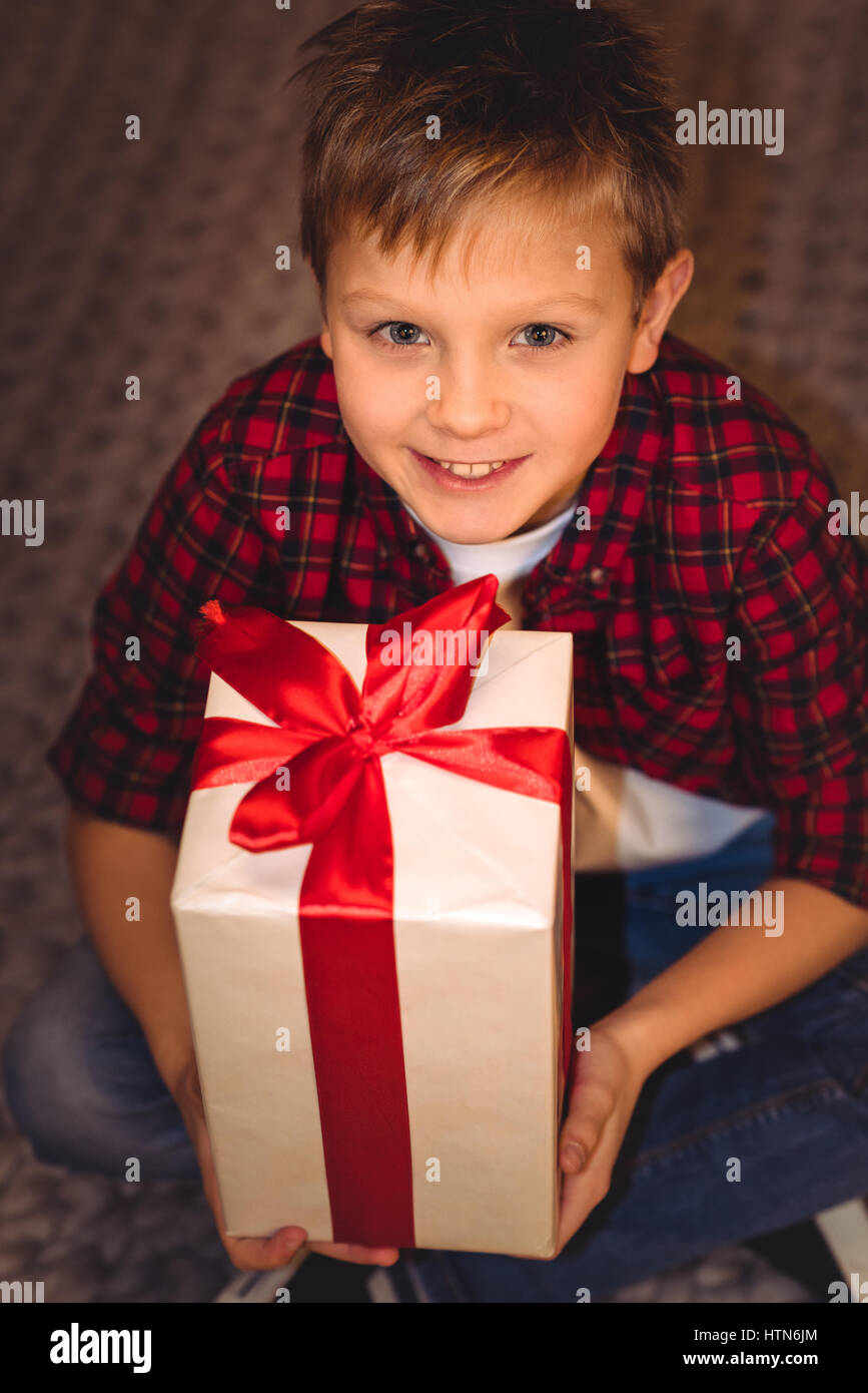 Boy holding gift box Stock Photo - Alamy