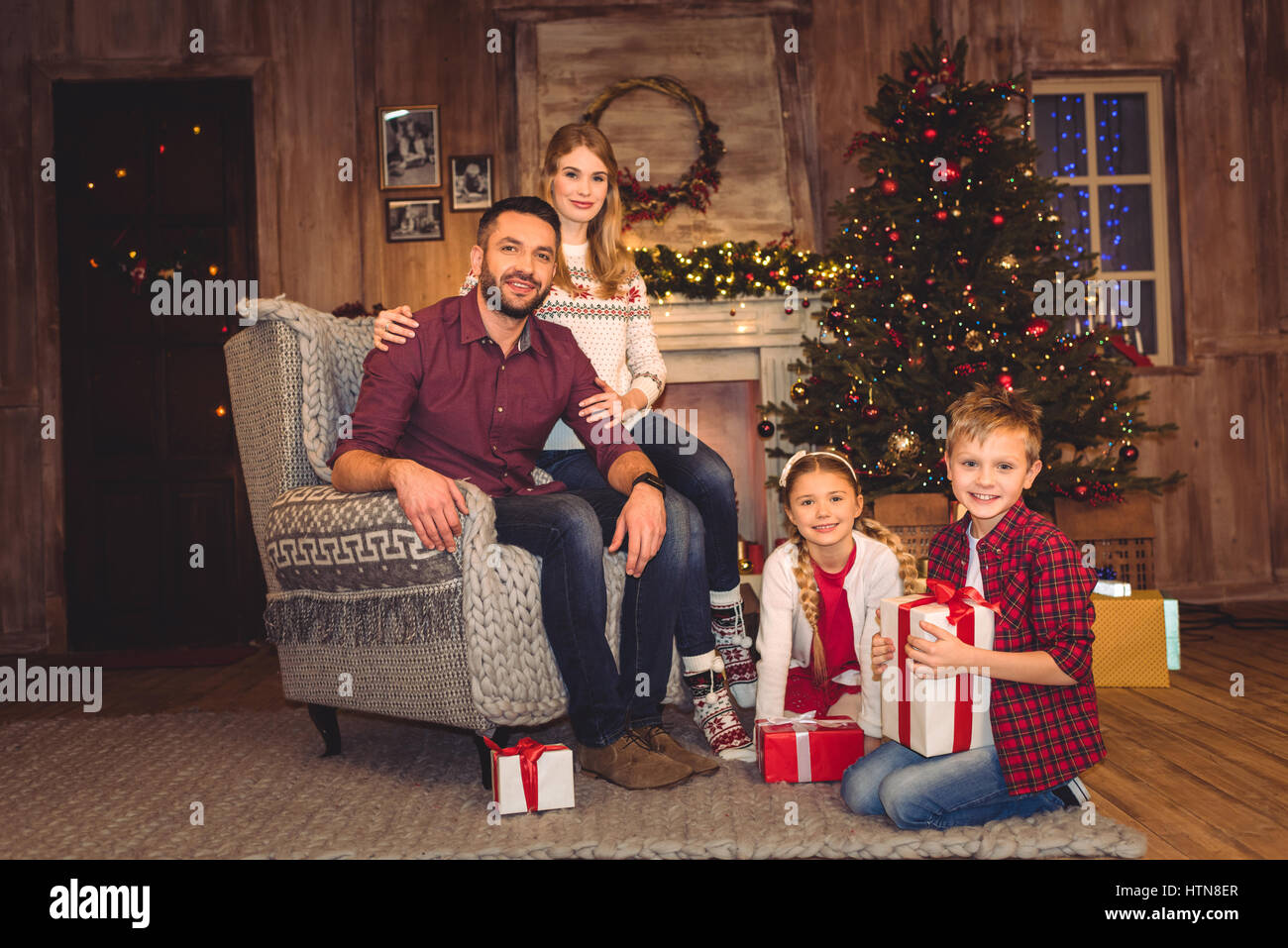 Happy family with christmas presents Stock Photo - Alamy
