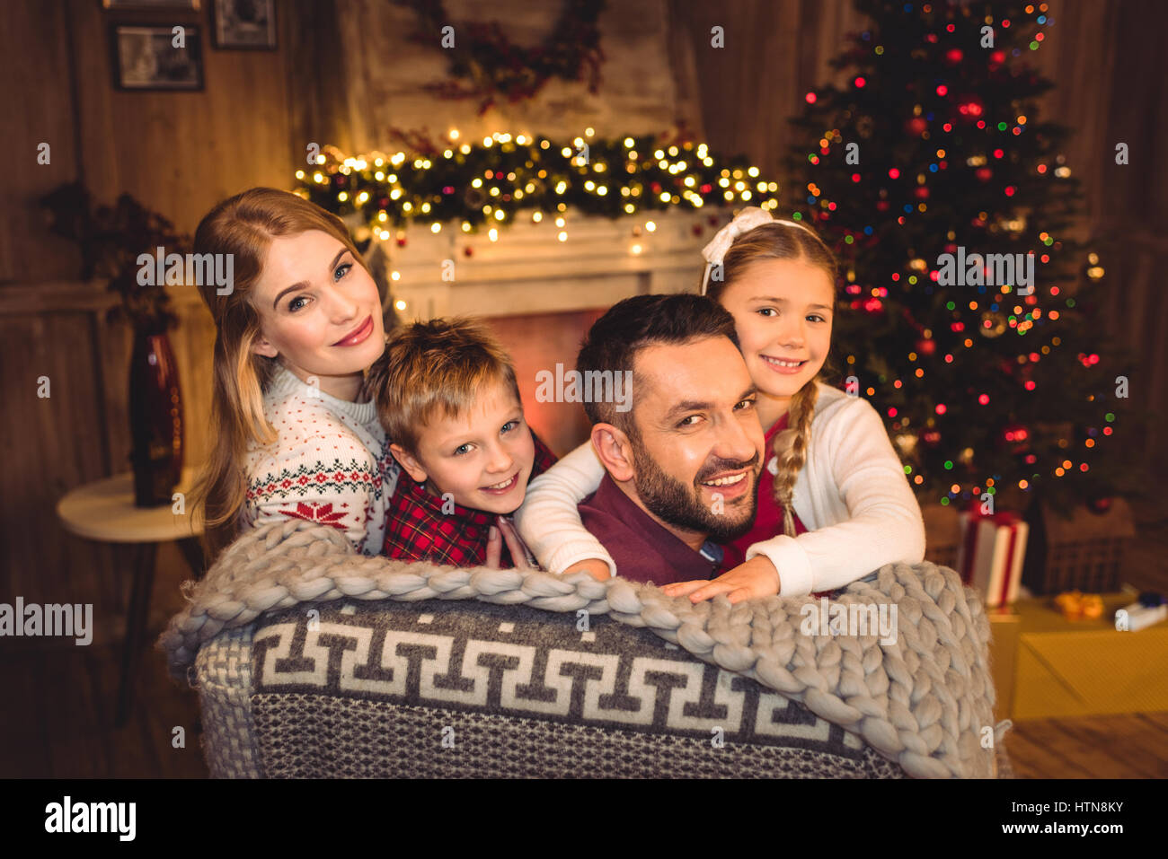 Happy family smiling at camera Stock Photo - Alamy