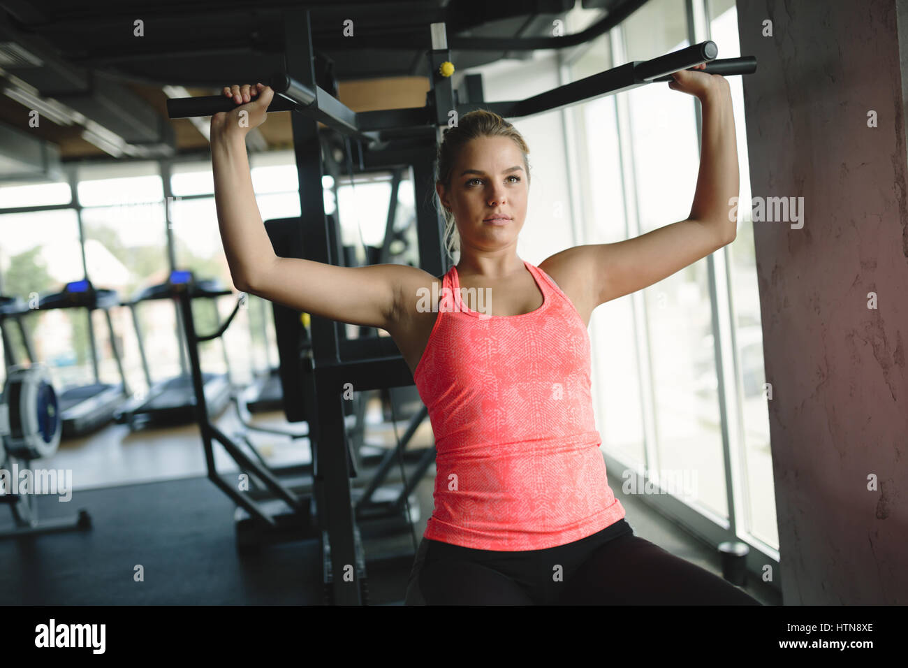 Athletic woman having fitness training and workout in gym Stock Photo ...